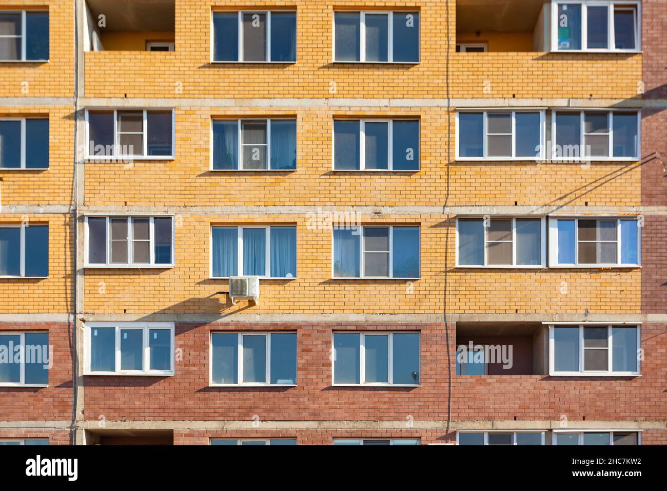 facade of a brick apartment building with windows and balconies Stock ...