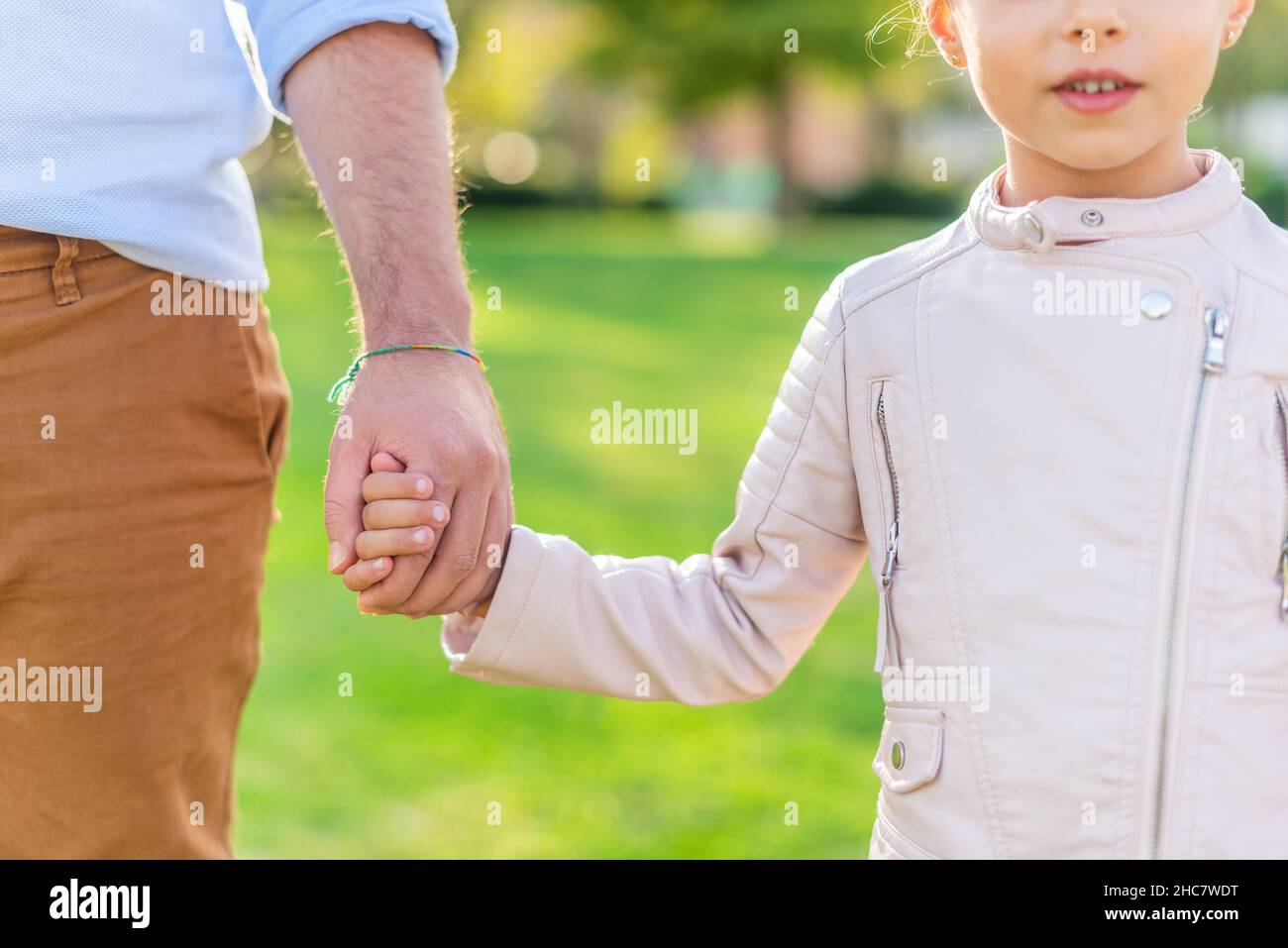 Close-up of the holding hands of daughter and father Stock Photo - Alamy