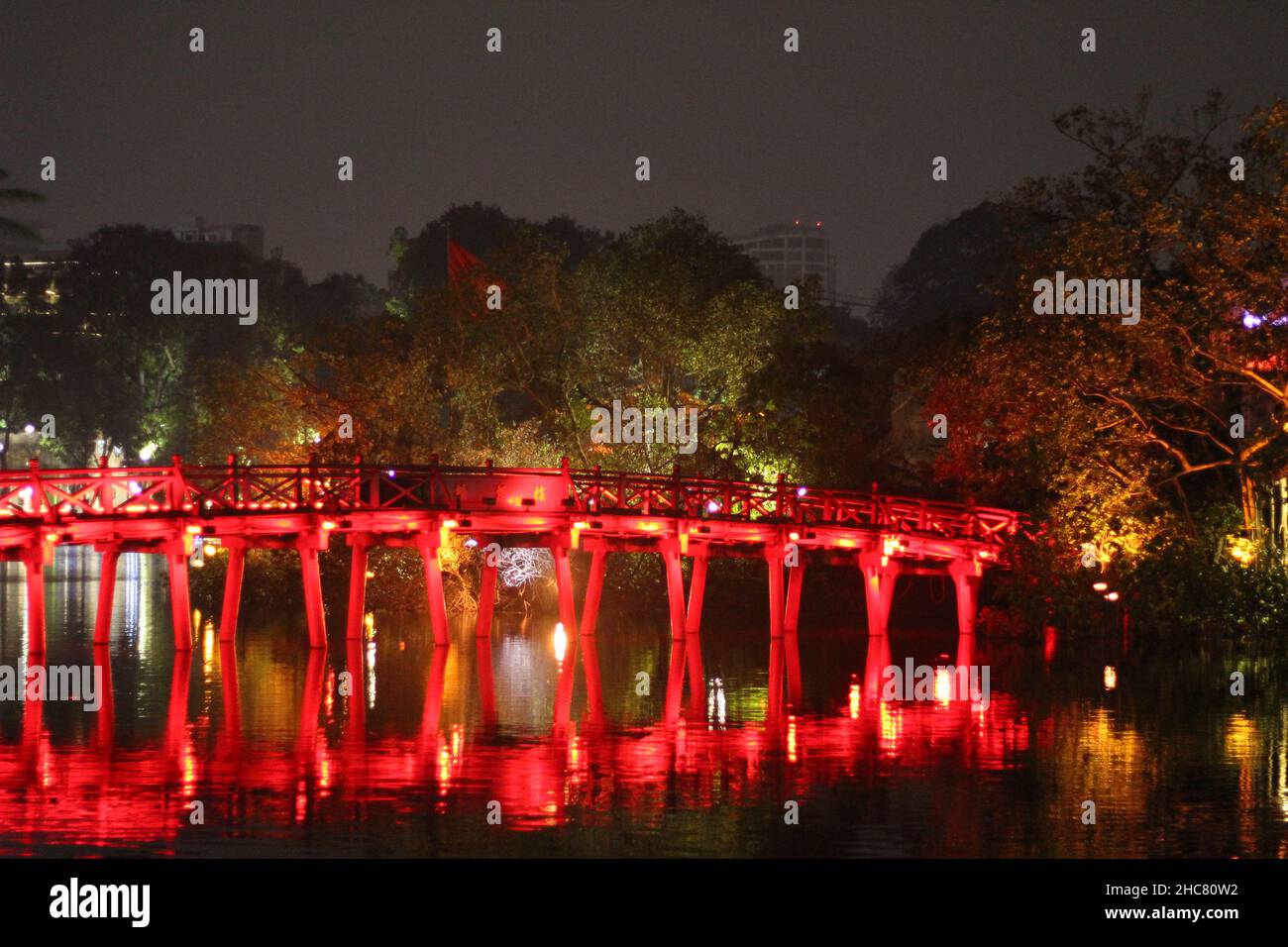 The wooden red-painted The Huc Bridge in Hanoi old Quarter at night ...