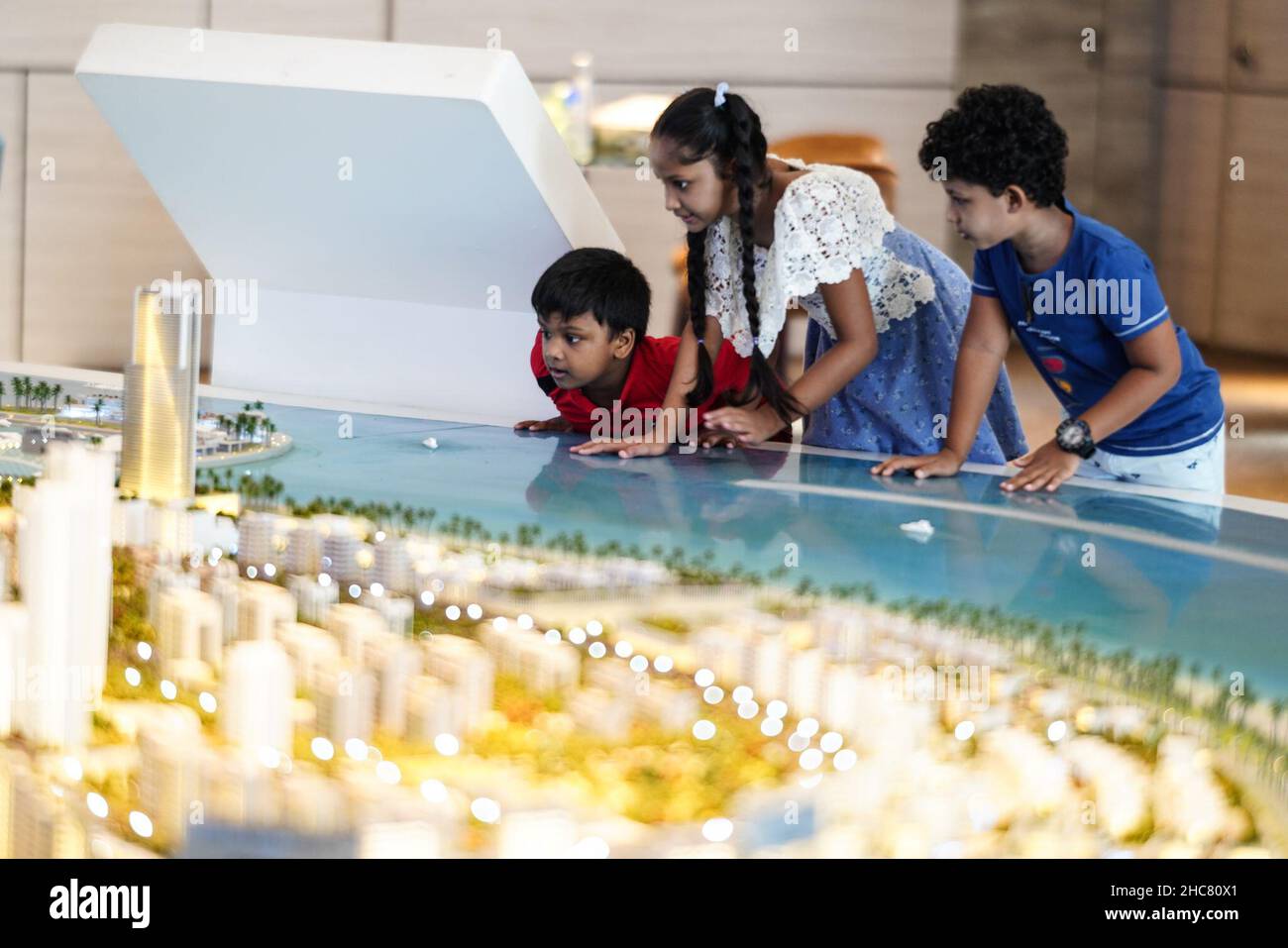 Colombo. 3rd Dec, 2021. Children look at a sand table model of the ...