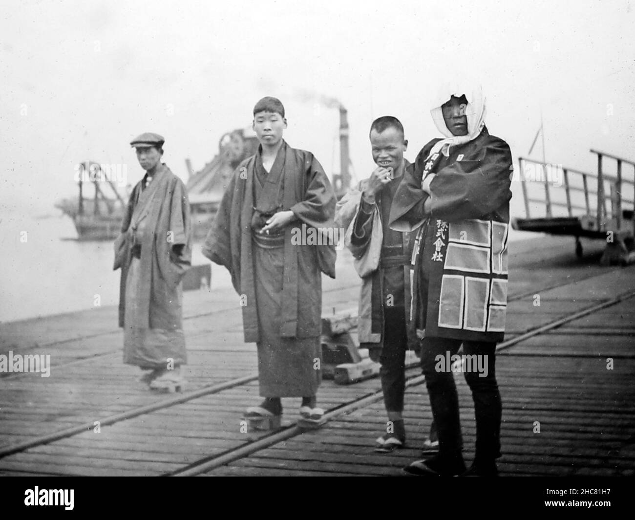 A clerk and carriers, Yokohama docks, Japan, early 1900s Stock Photo ...