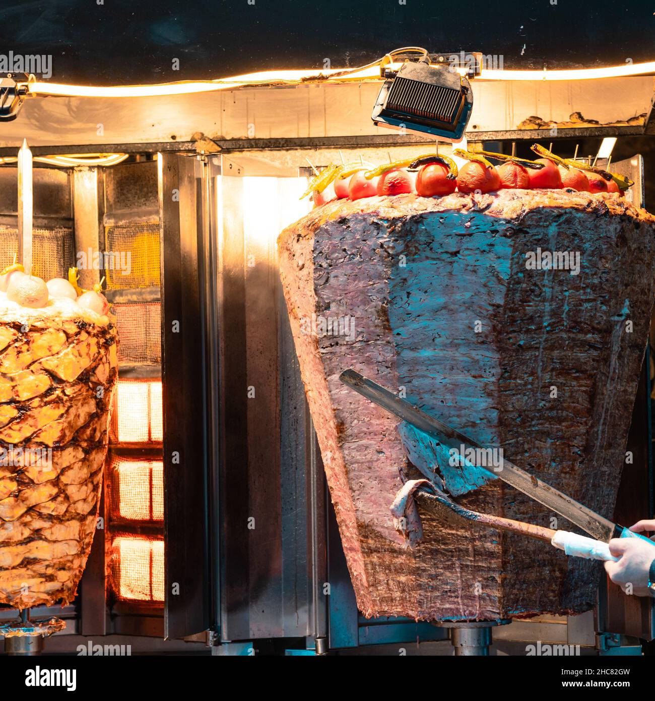 Doner Kebab. Chef cutting famous Turkish street food Chicken and meat ...