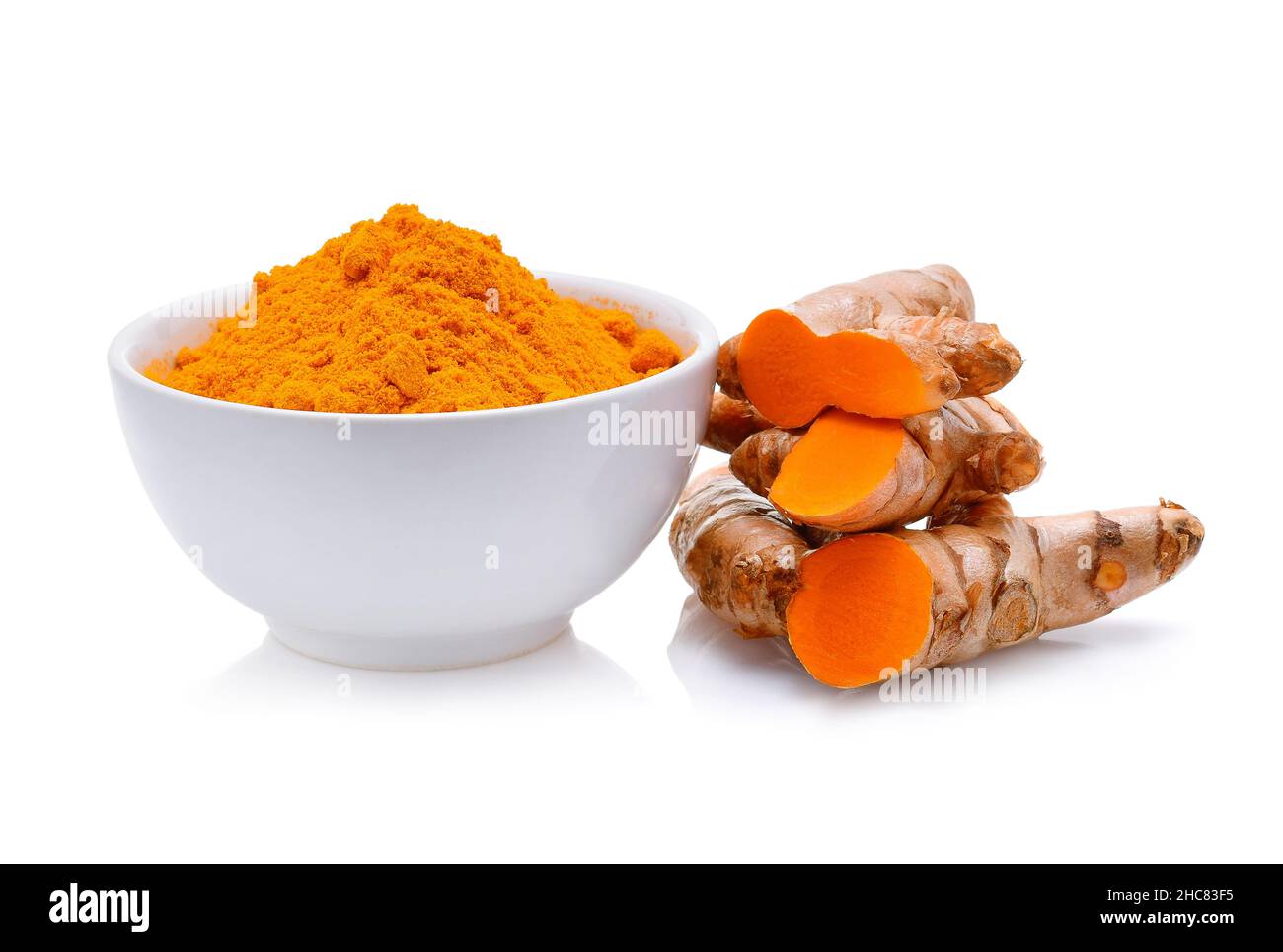 Turmeric roots and turmeric powder in white bowl isolated on white ...