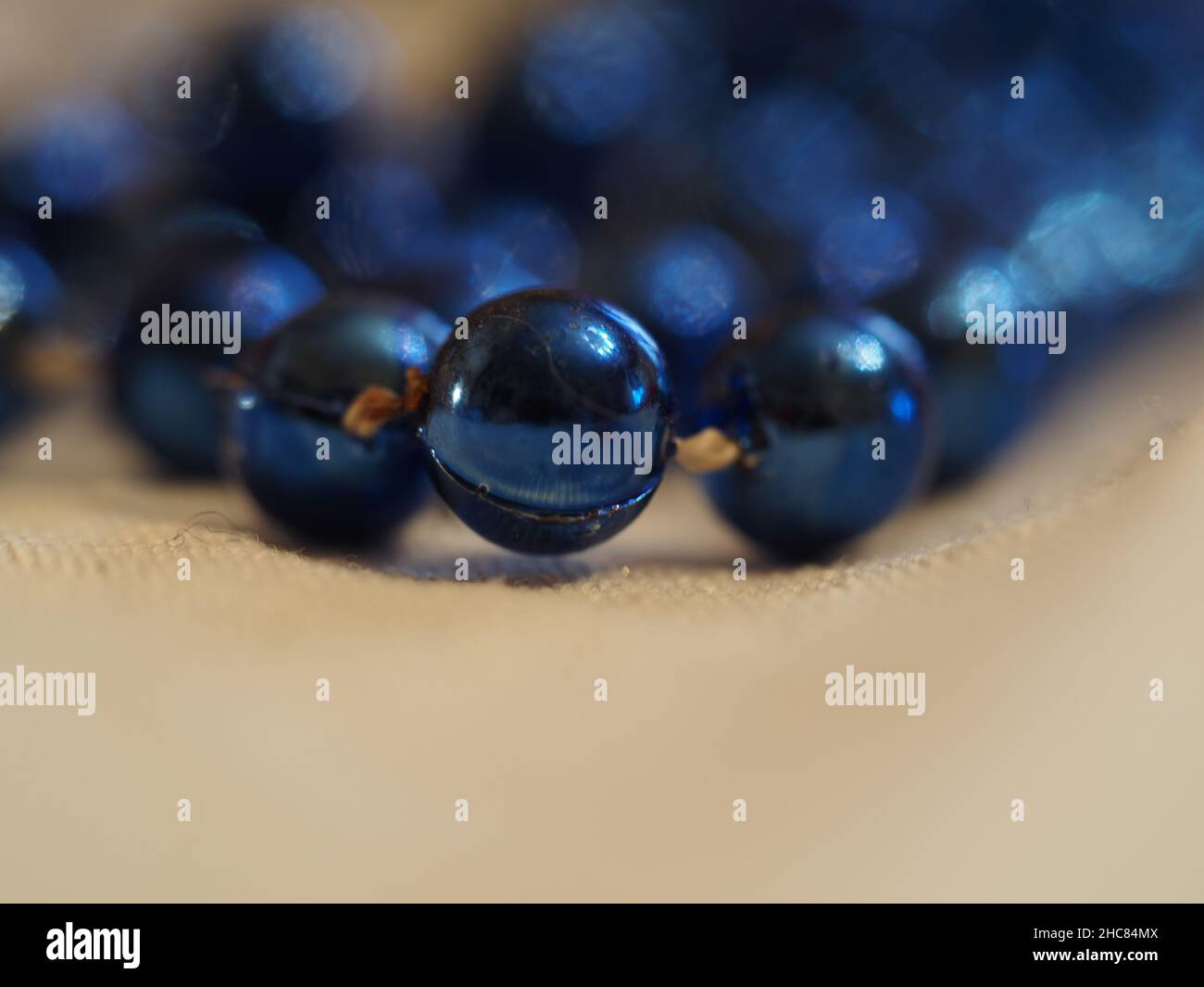 Blue pearls plastic fake necklage detail Stock Photo - Alamy