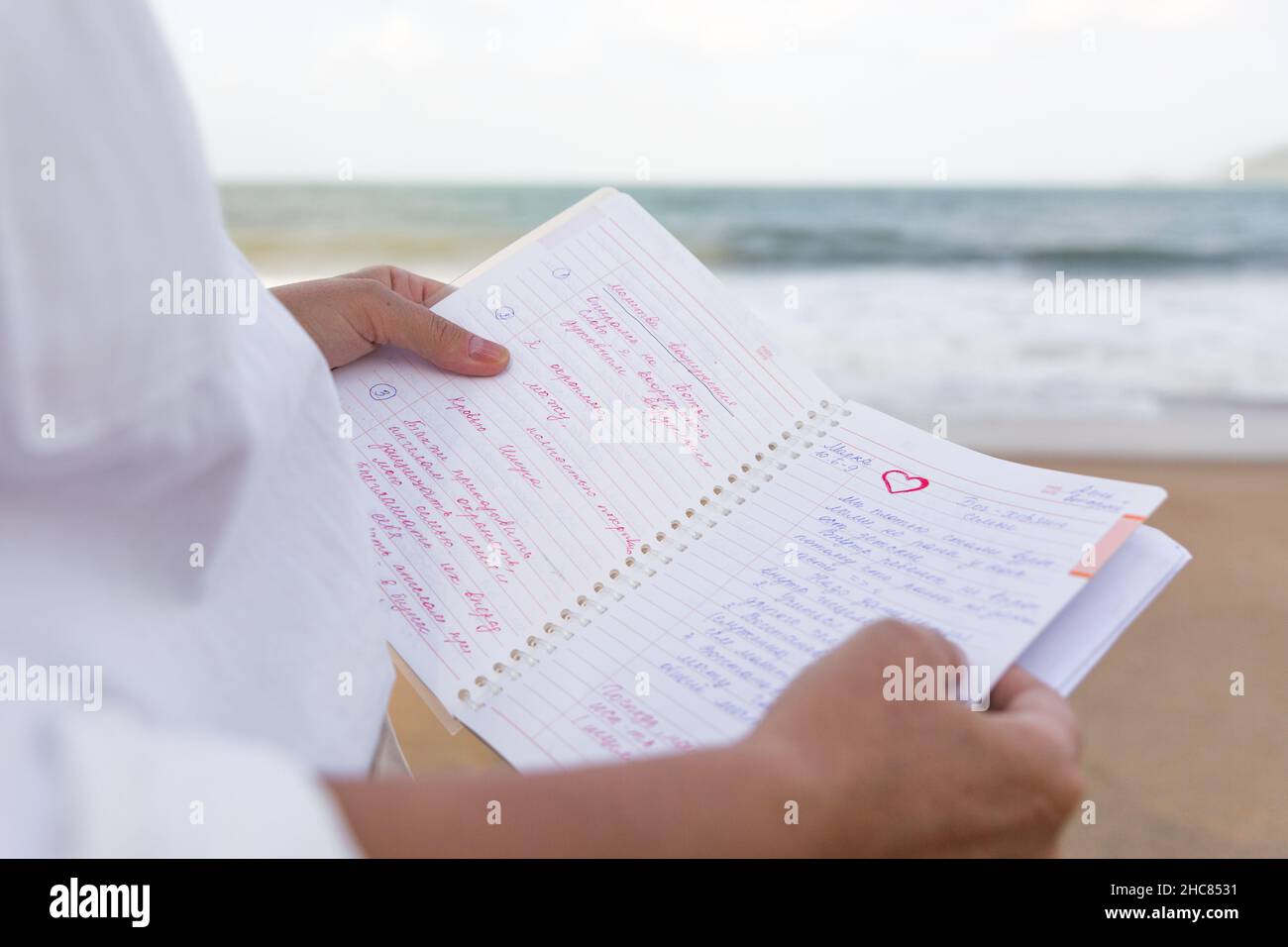 notebook, woman read your notes near the sea Stock Photo - Alamy