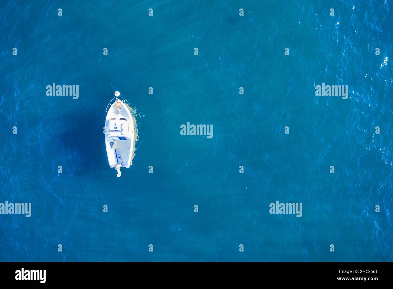 Empty fishing boat from above in atlantic. Aerial view of small white ...