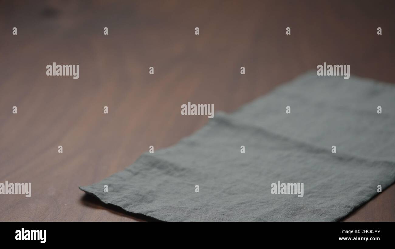 Teal linen cloth on walnut wood table background, shallow focus Stock ...
