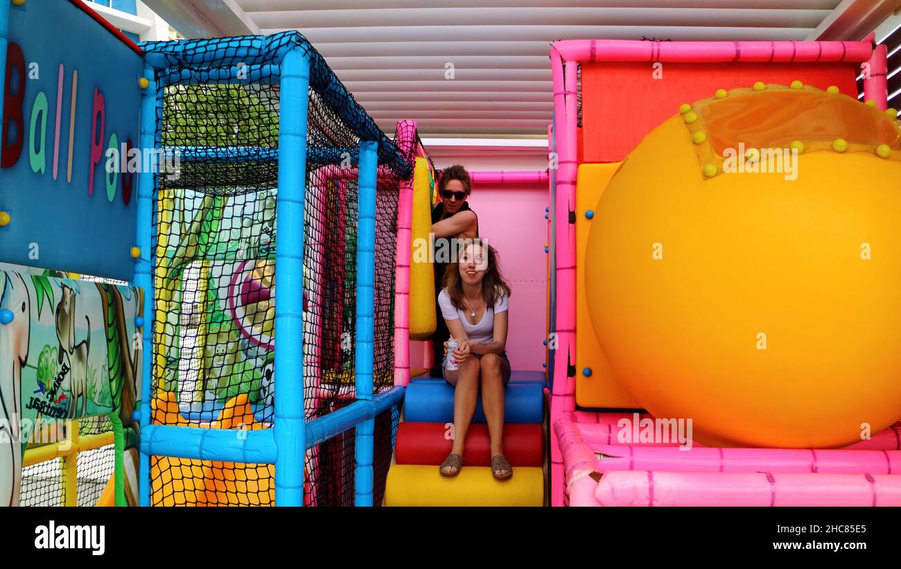 Adult children having fun in kids playground at Gold Coast Australia ...