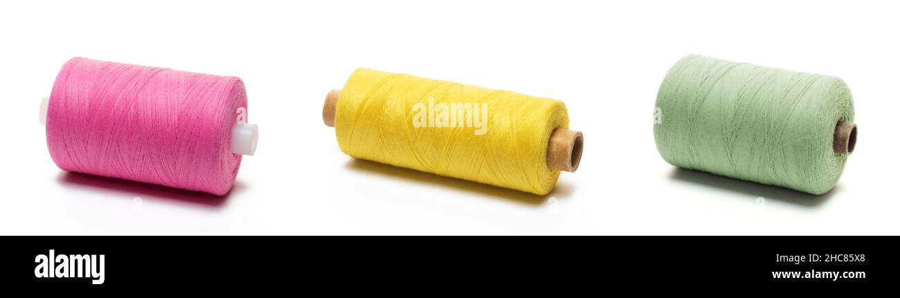 Set of pink, yellow, green threads on white background. Sewing concept ...
