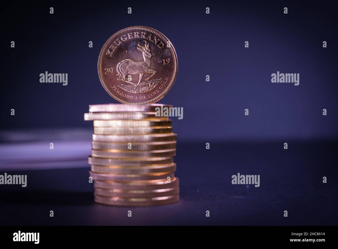 Krugerrand gold coin stands on a stack of other gold coins Stock Photo ...