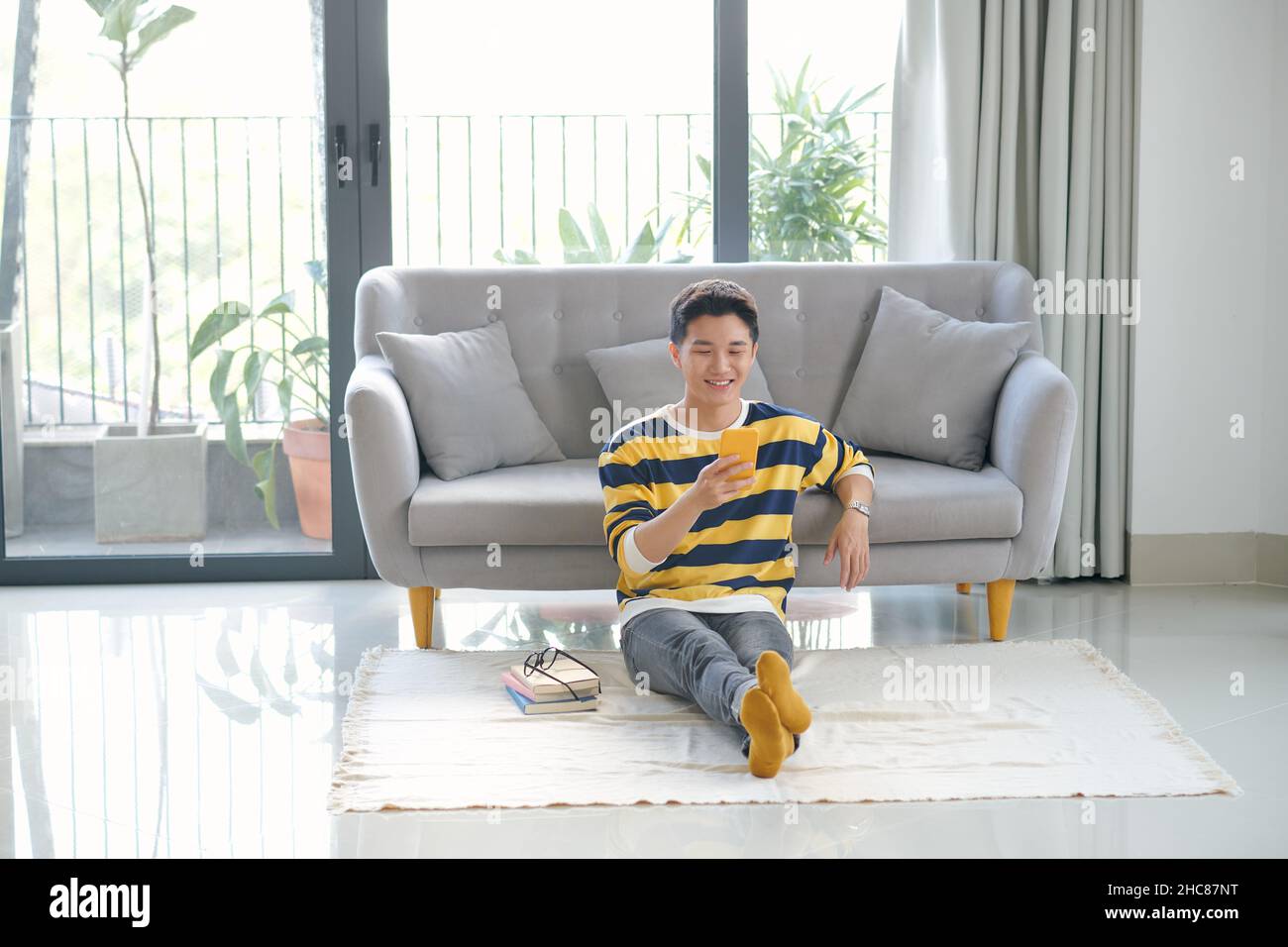 He has a good time in his home on the weekend sitting on the floor and ...