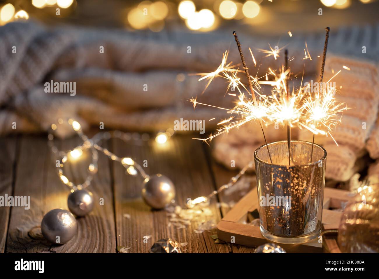 Cozy Christmas background with glowing sparklers and decor details ...