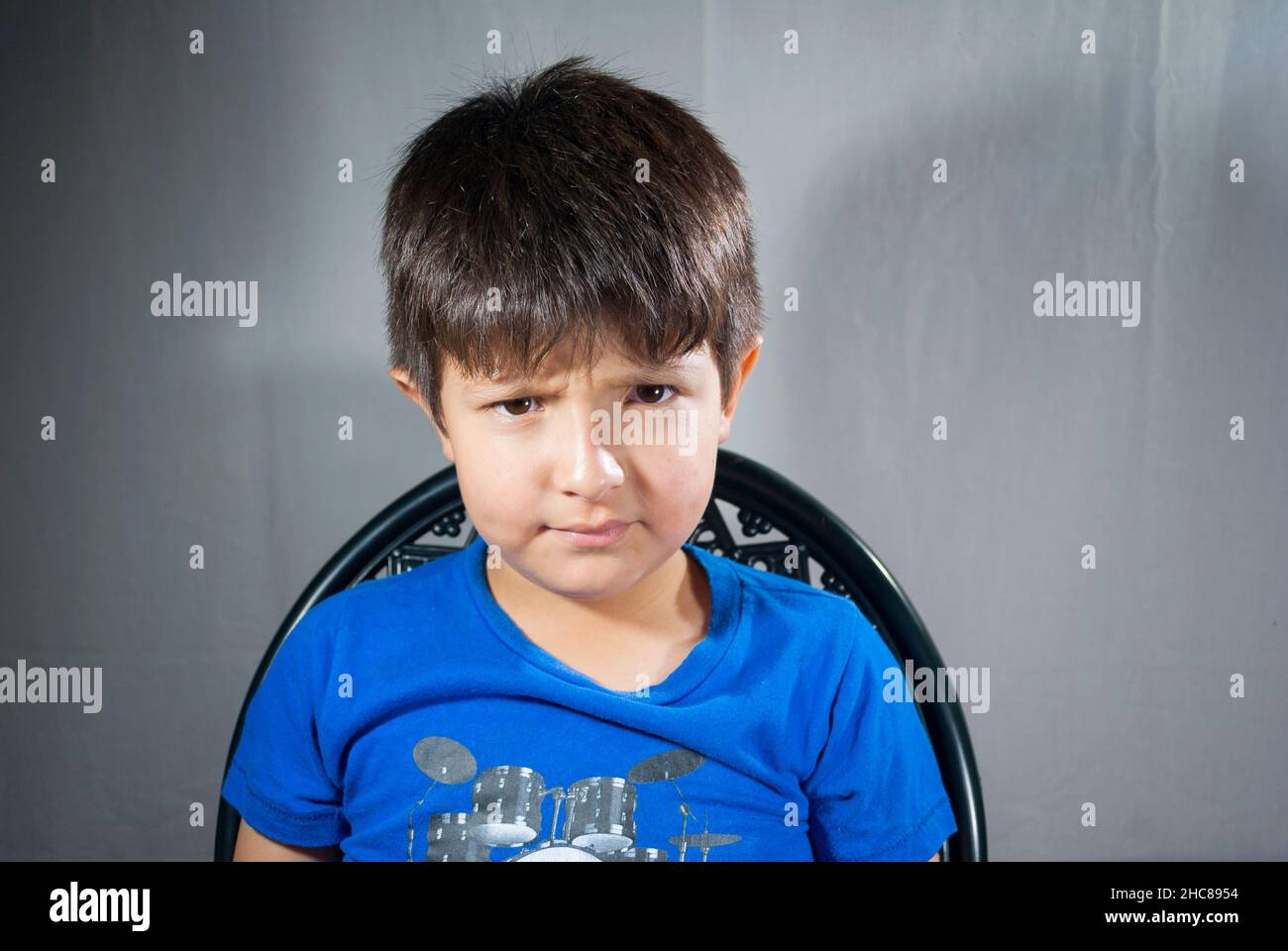 Young boy posing to the camera showing his face and expressions Stock ...