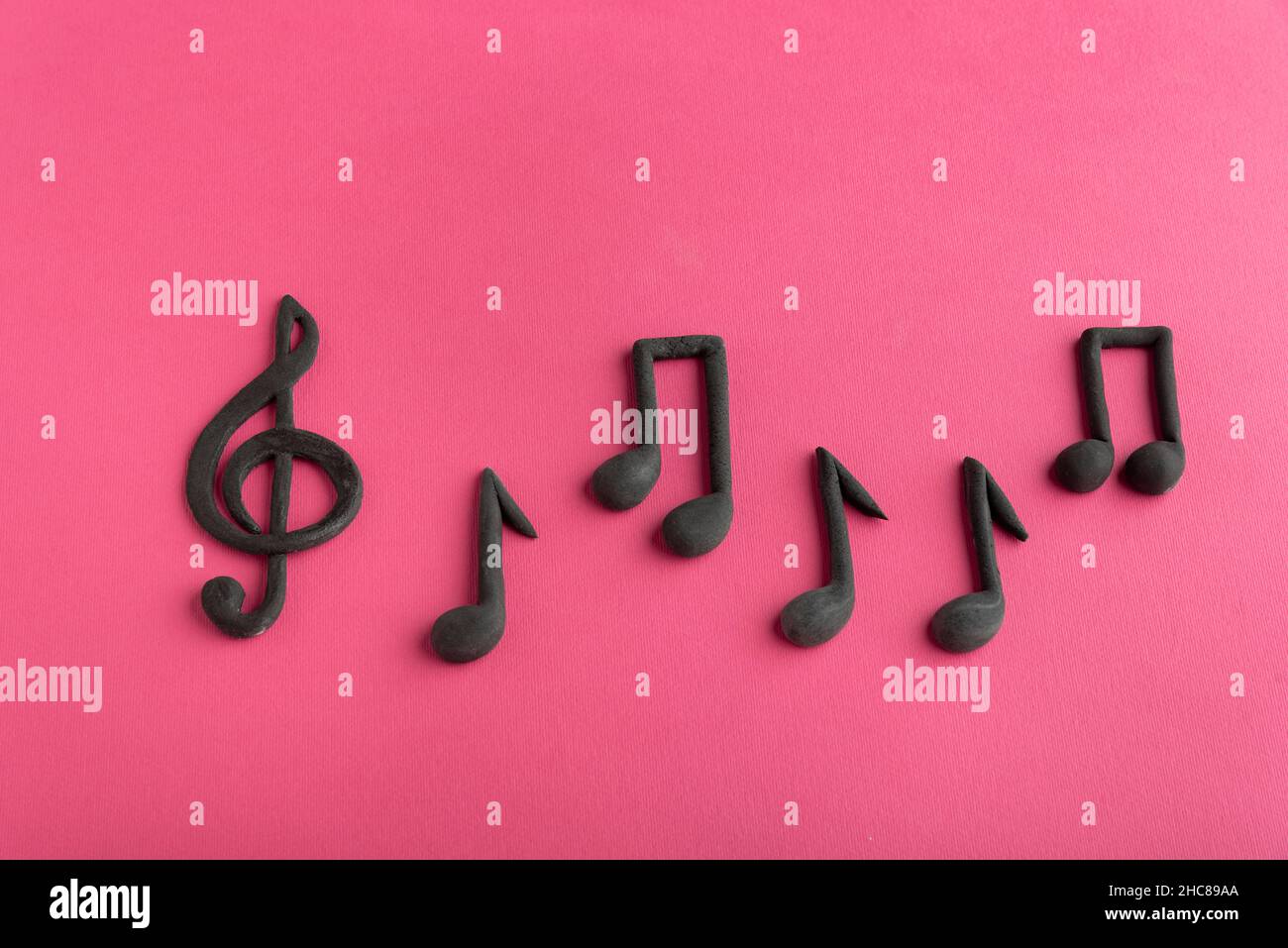 Treble clef and music notes on pink background. Music symbol. Key of G ...