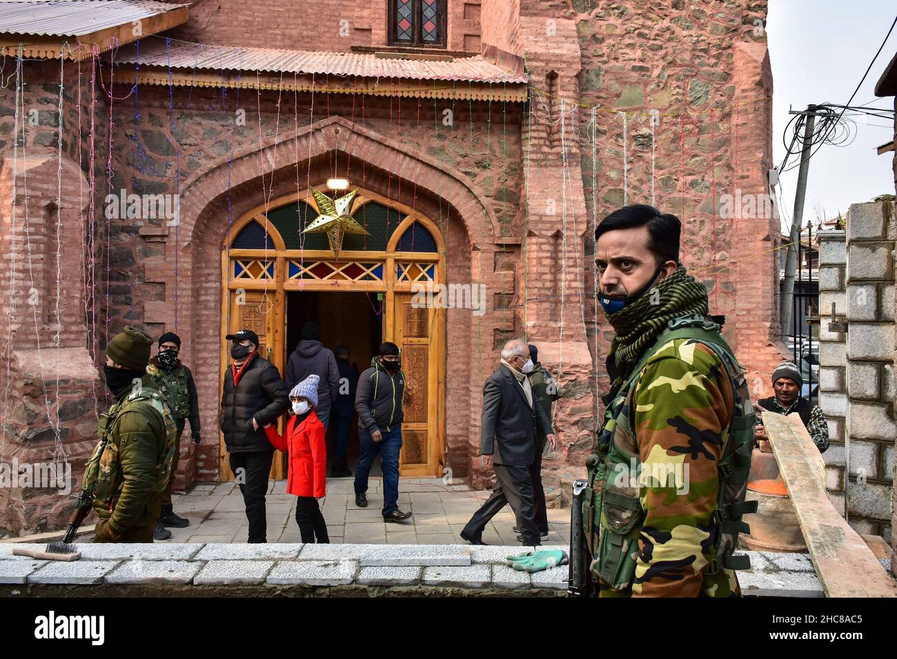 Policemen stand alert as Christian devotees walk in the compound of St ...