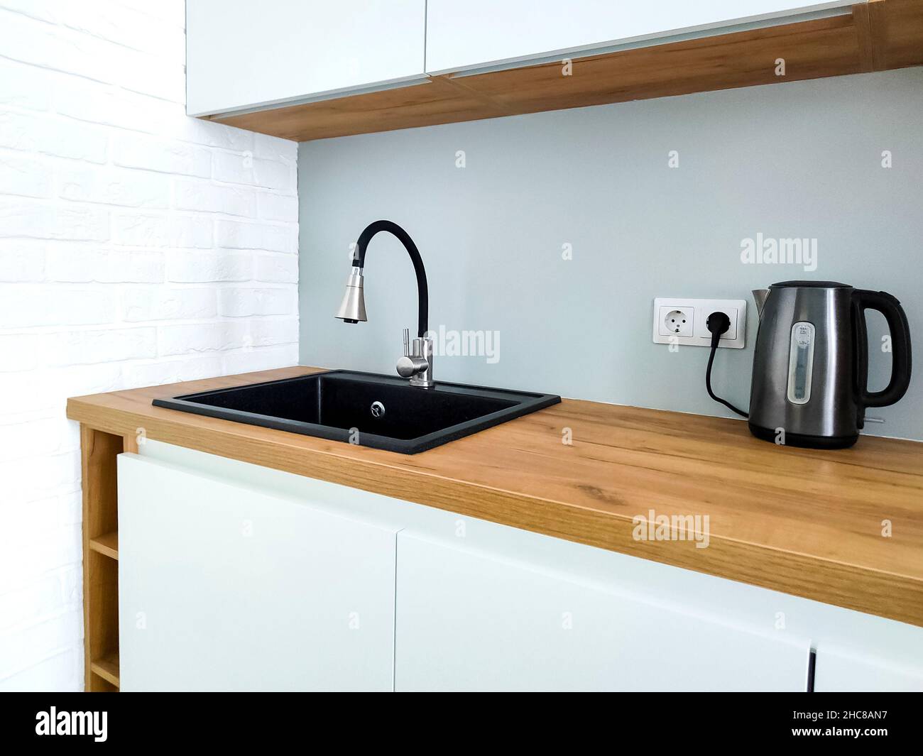 Black sink with flexible faucet in Scandi kitchen interior Stock Photo ...