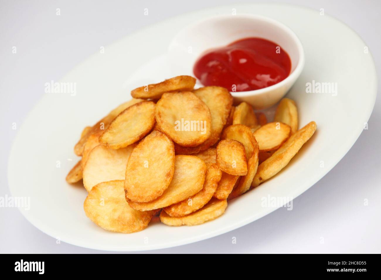 Potato Crisps with Ketchup Stock Photo - Alamy