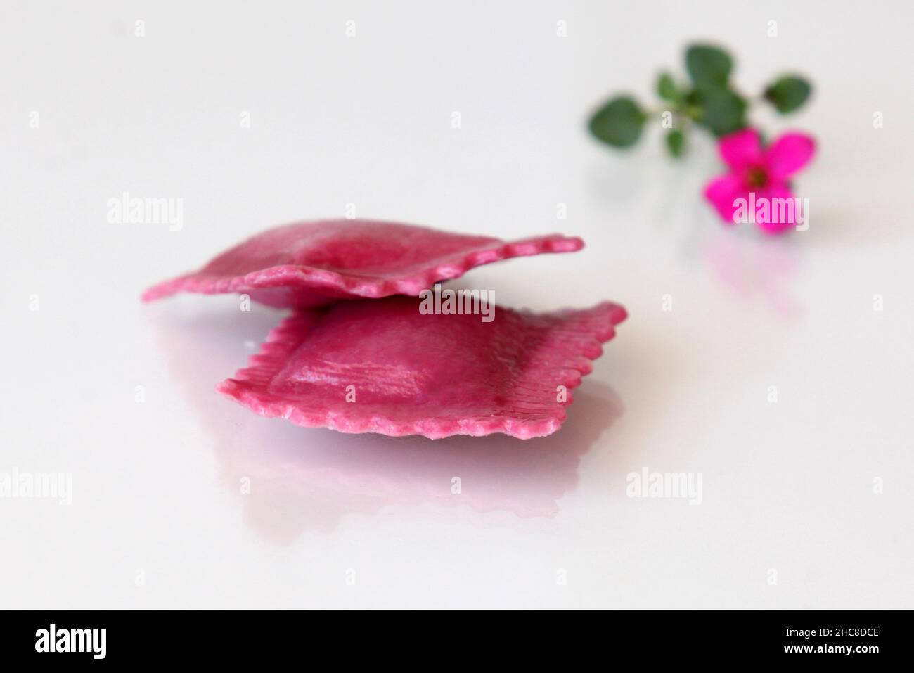 Fresh uncooked tomato flavoured Ravioli (Stuffed Pasta) on white ...