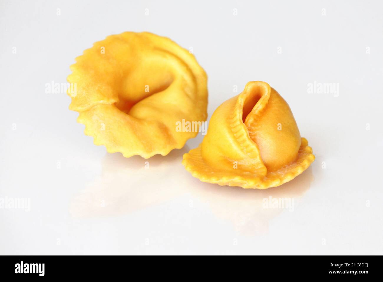 Fresh uncooked round Ravioli (Stuffed Pasta) on white background Stock ...