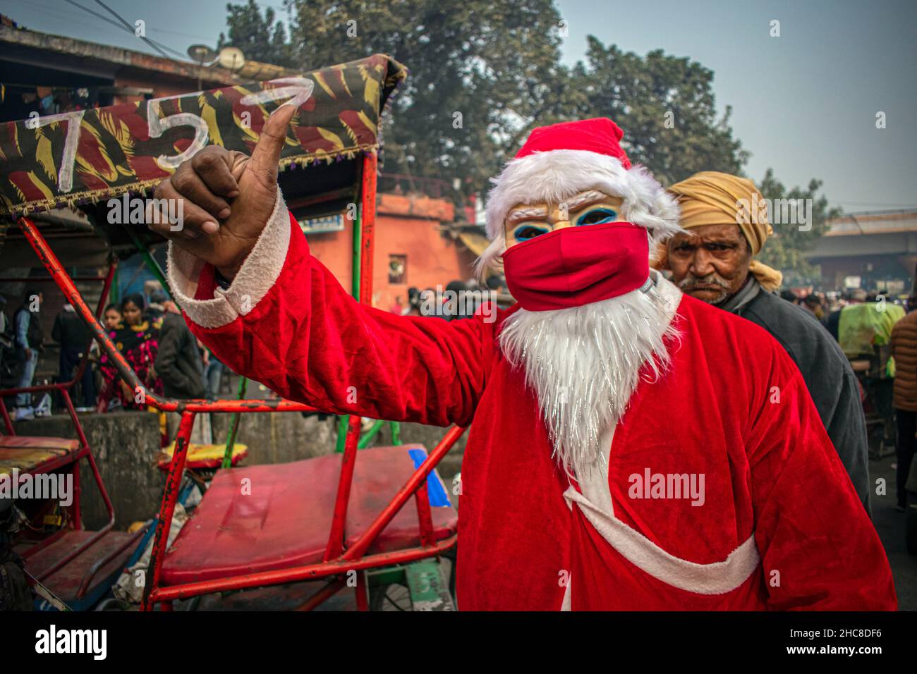 New Delhi, India. 25th Dec, 2021. A man dressed as Santa Claus ...