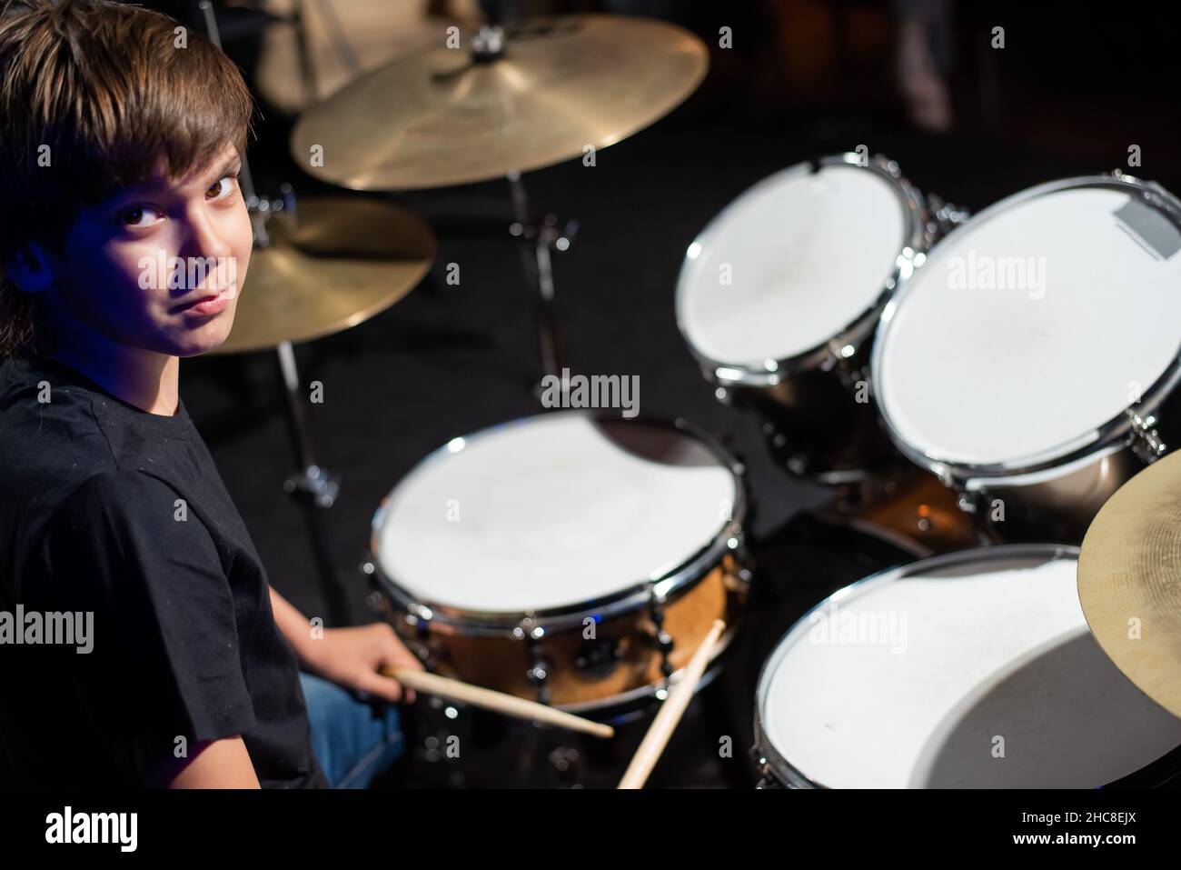 A boy plays drums in a recording studio Stock Photo - Alamy