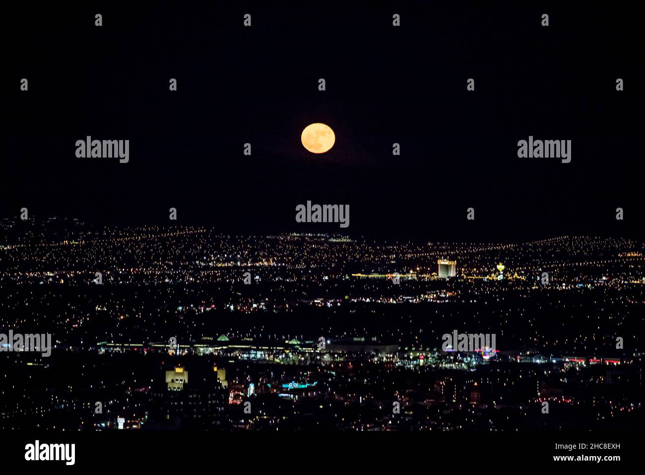 Super moon rising over an aerial view of Las Vegas city at night ...