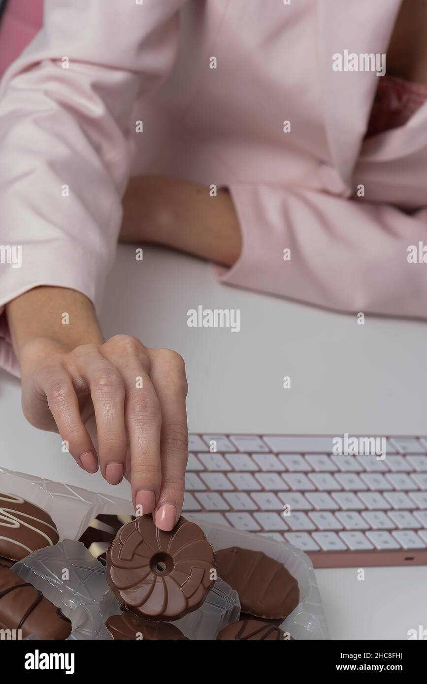 Chocolate biscuits in plastic box by a keboaard, a temptation for a ...