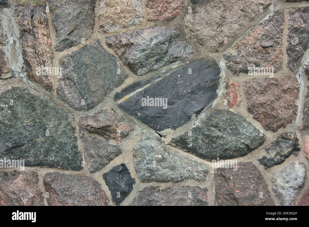 Old stone wall built from huge granite boulders, stones, and rocks ...