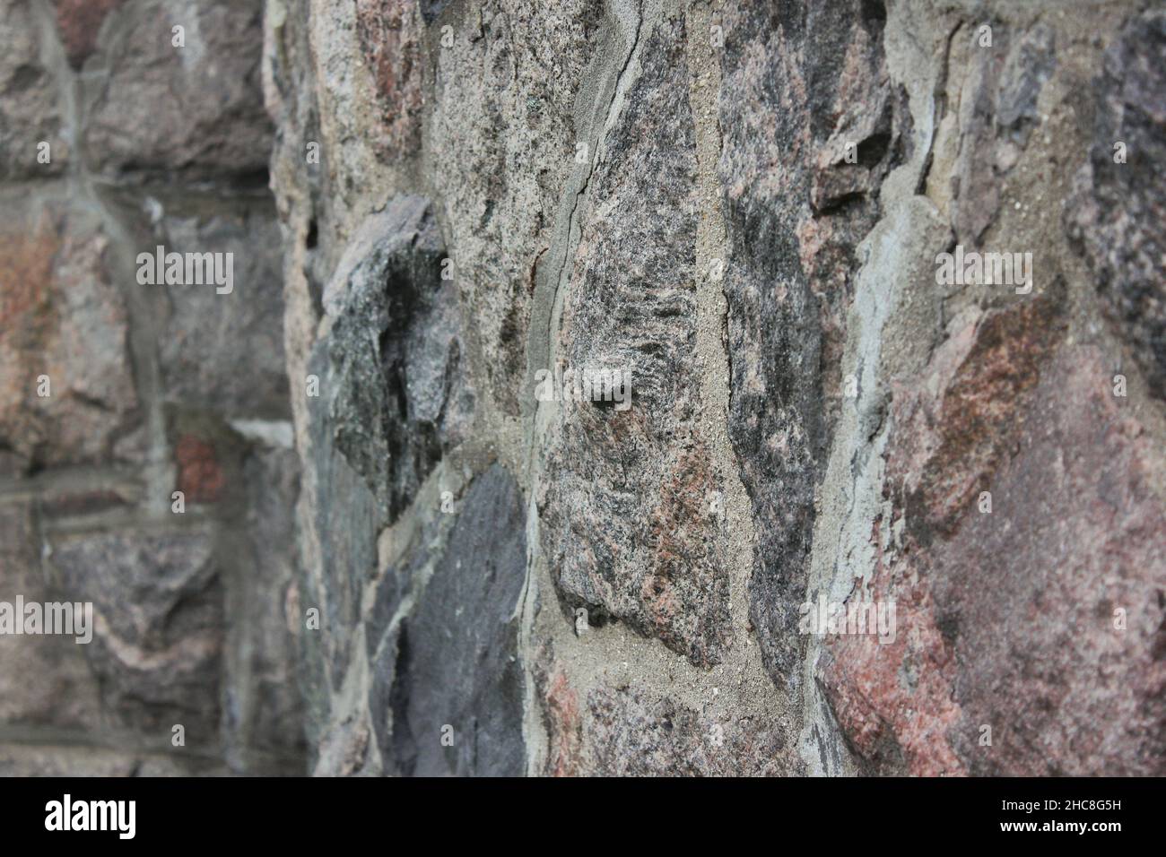 Old stone wall built from huge granite boulders, stones, and rocks ...