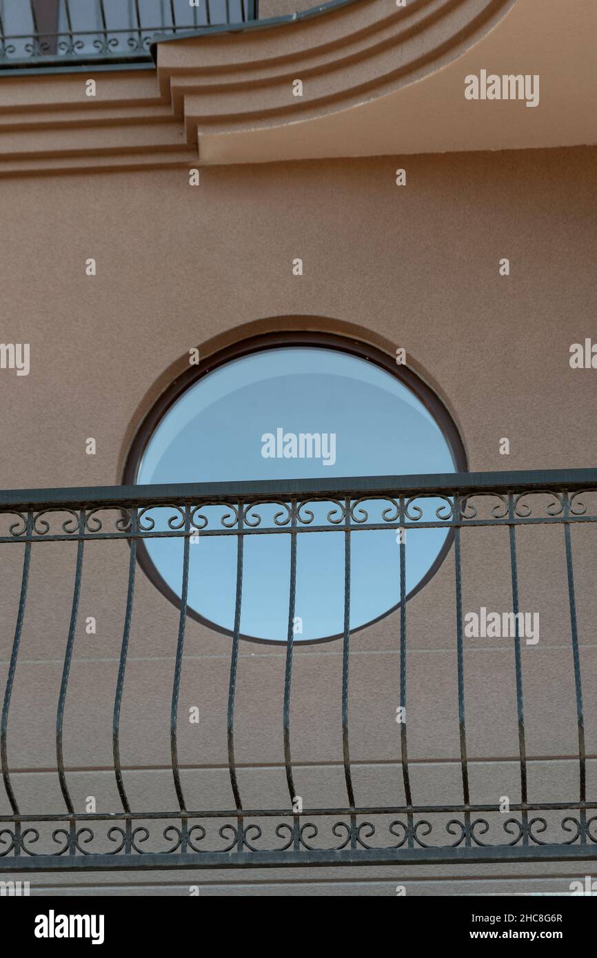 Metal fence of the balcony on round window background. Modern ...