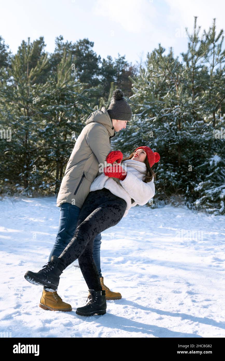 Loving couple dancing in winter forest. Frosty clear day. Vertical ...