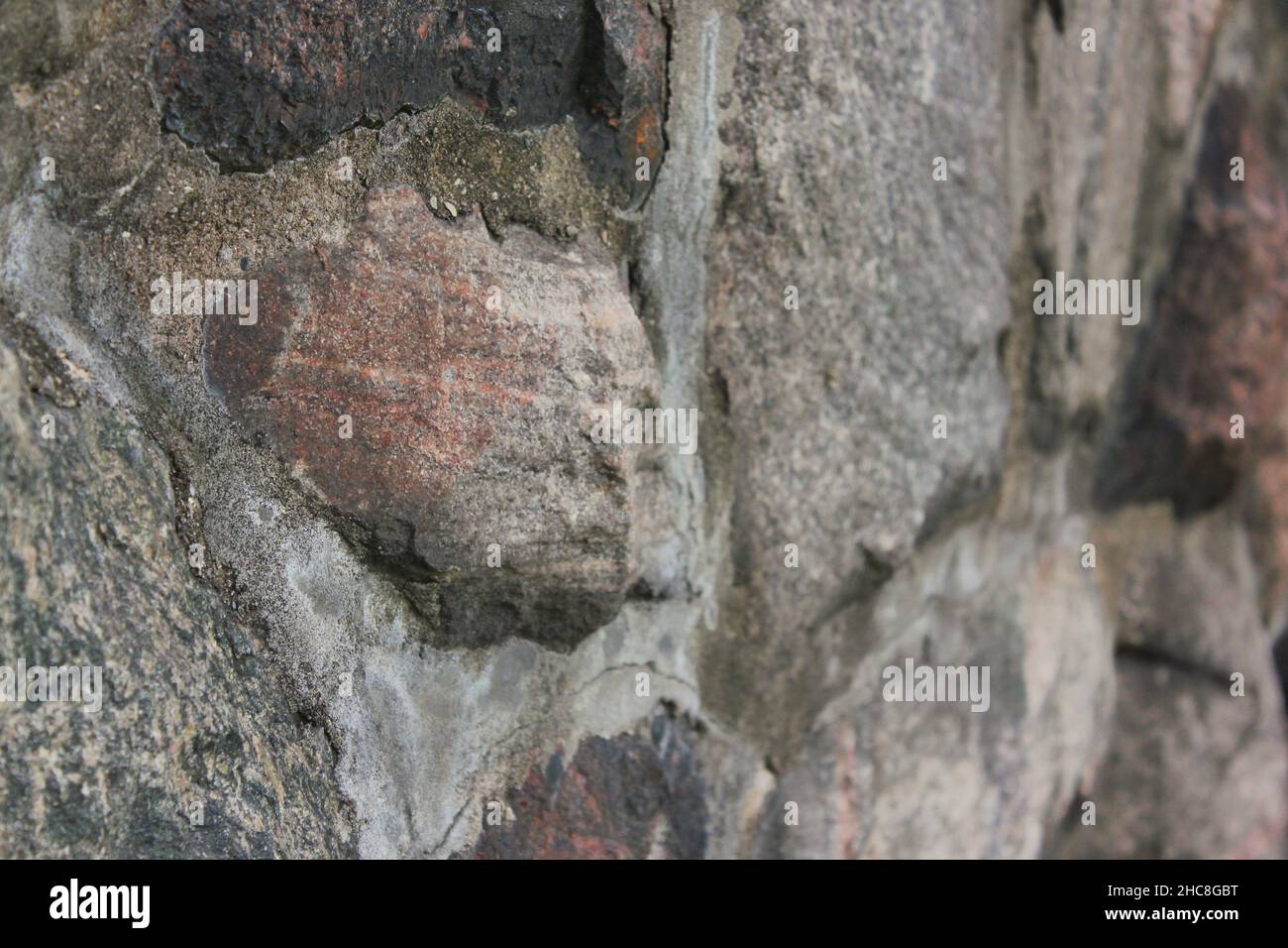 Old stone wall built from huge granite boulders, stones, and rocks ...