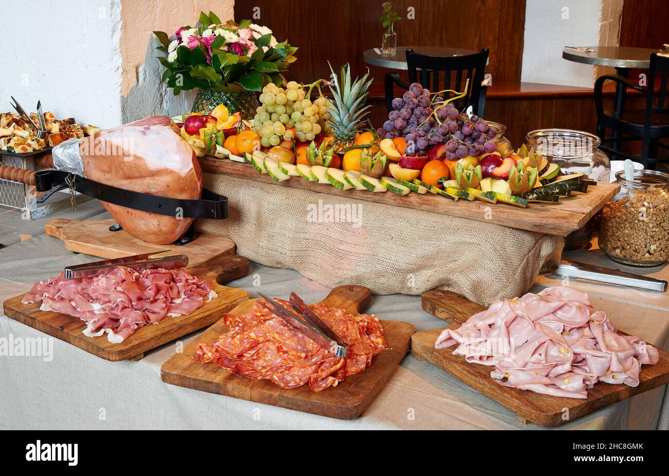 Colored buffet with seasonal fresh fruits and different kind of Ham ...