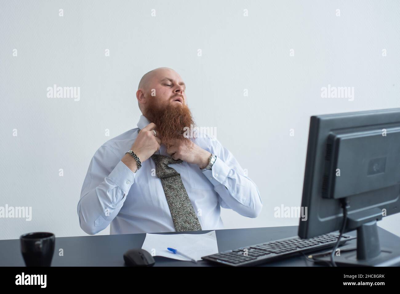Problems for the office worker. A bald man in a white shirt sits at a ...