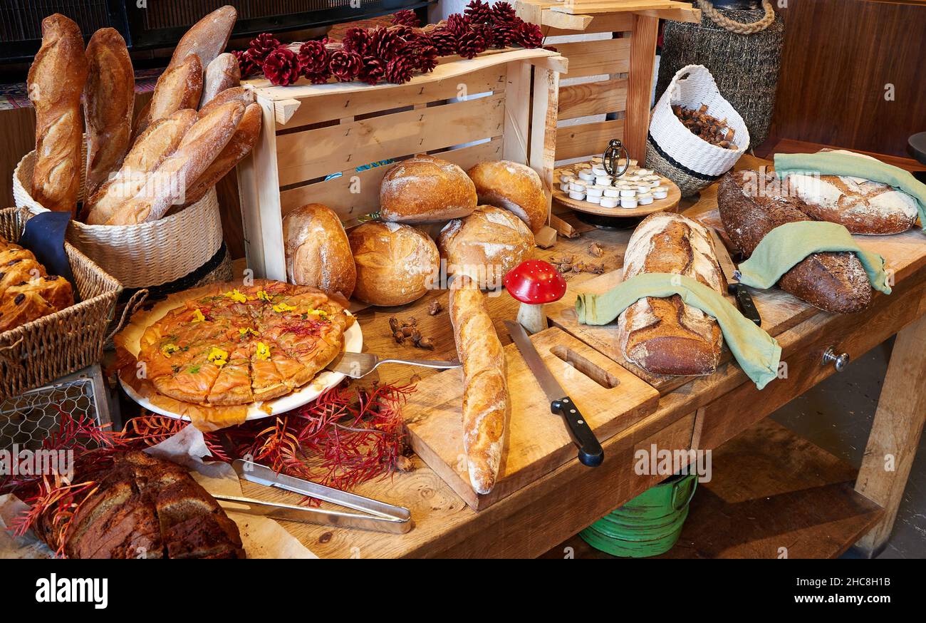 Various and Colored baked Bread buffet on Butcher board Stock Photo - Alamy
