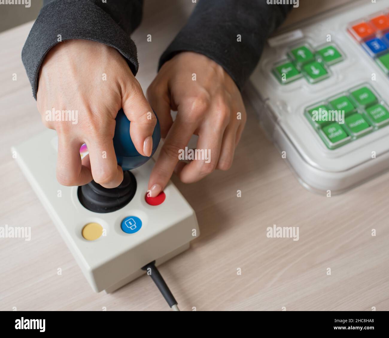 Woman with cerebral palsy works on a specialized computer mouse Stock ...