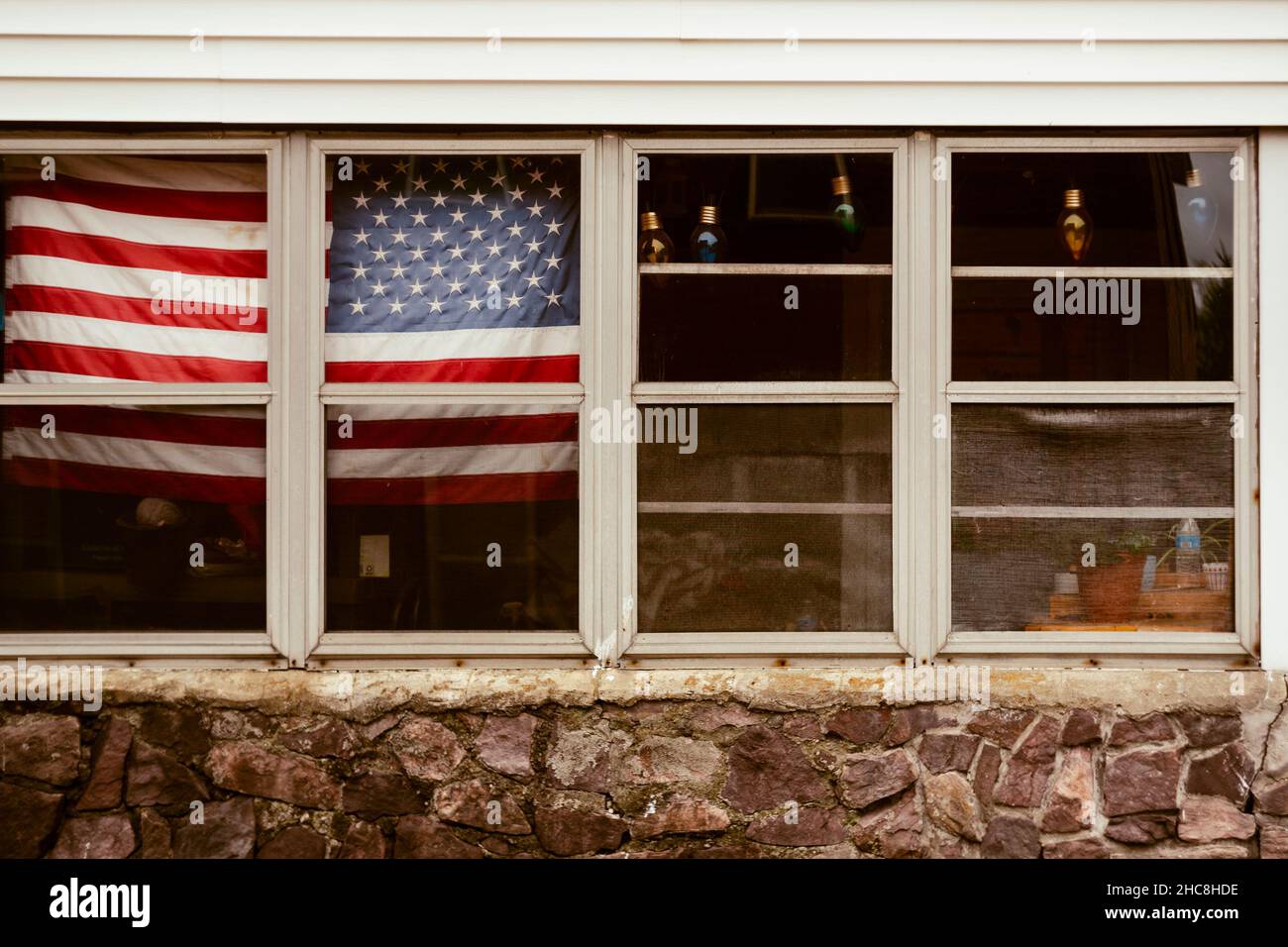 American flag attached to the window in a house in Vermont Stock Photo ...