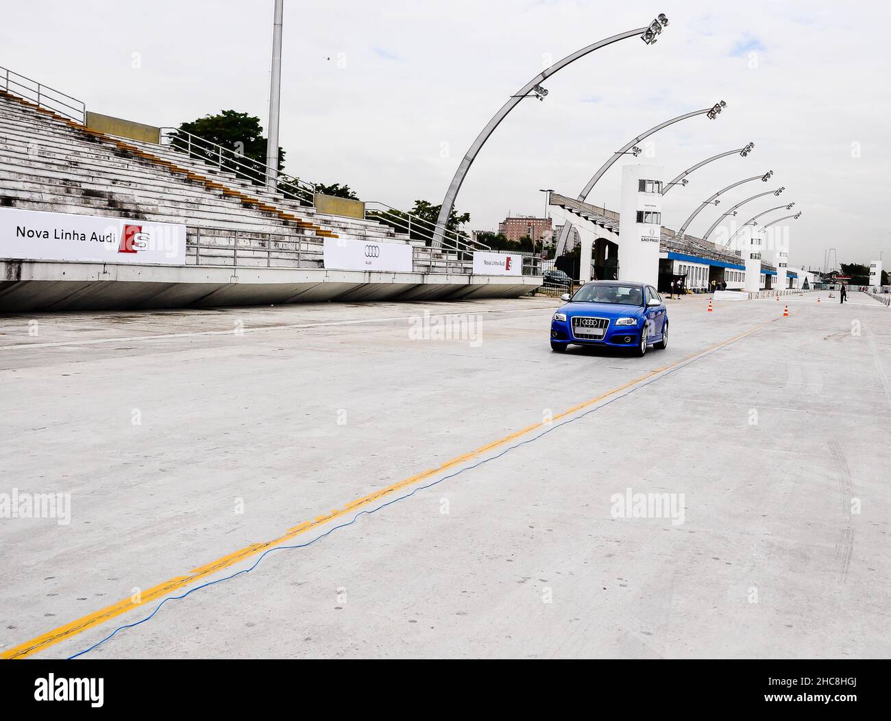 Close-up shot of a man driving a blue Audi line launch at Sao Paulo ...
