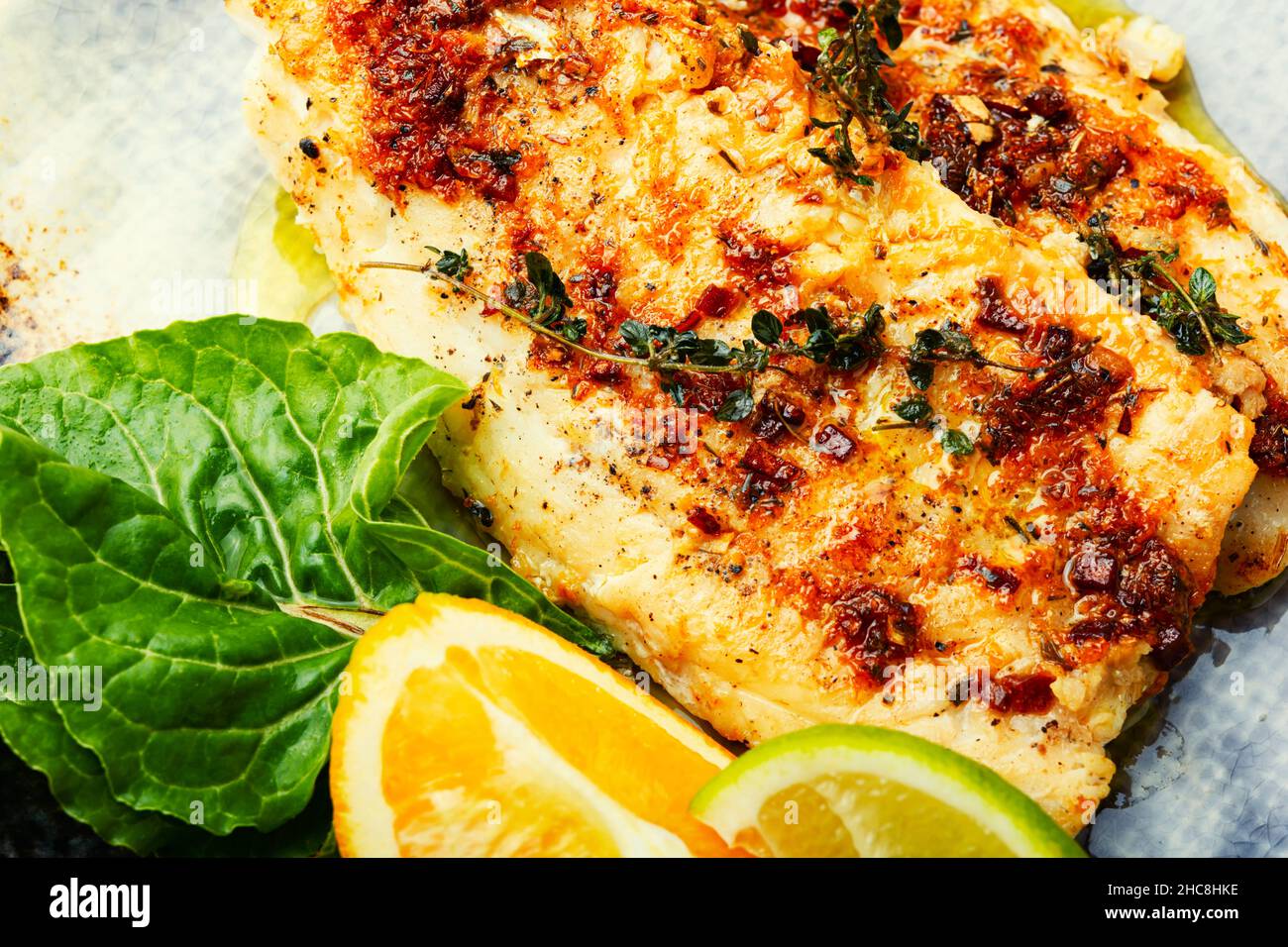 Fish fillet grilled with orange, delicious seafood Stock Photo - Alamy