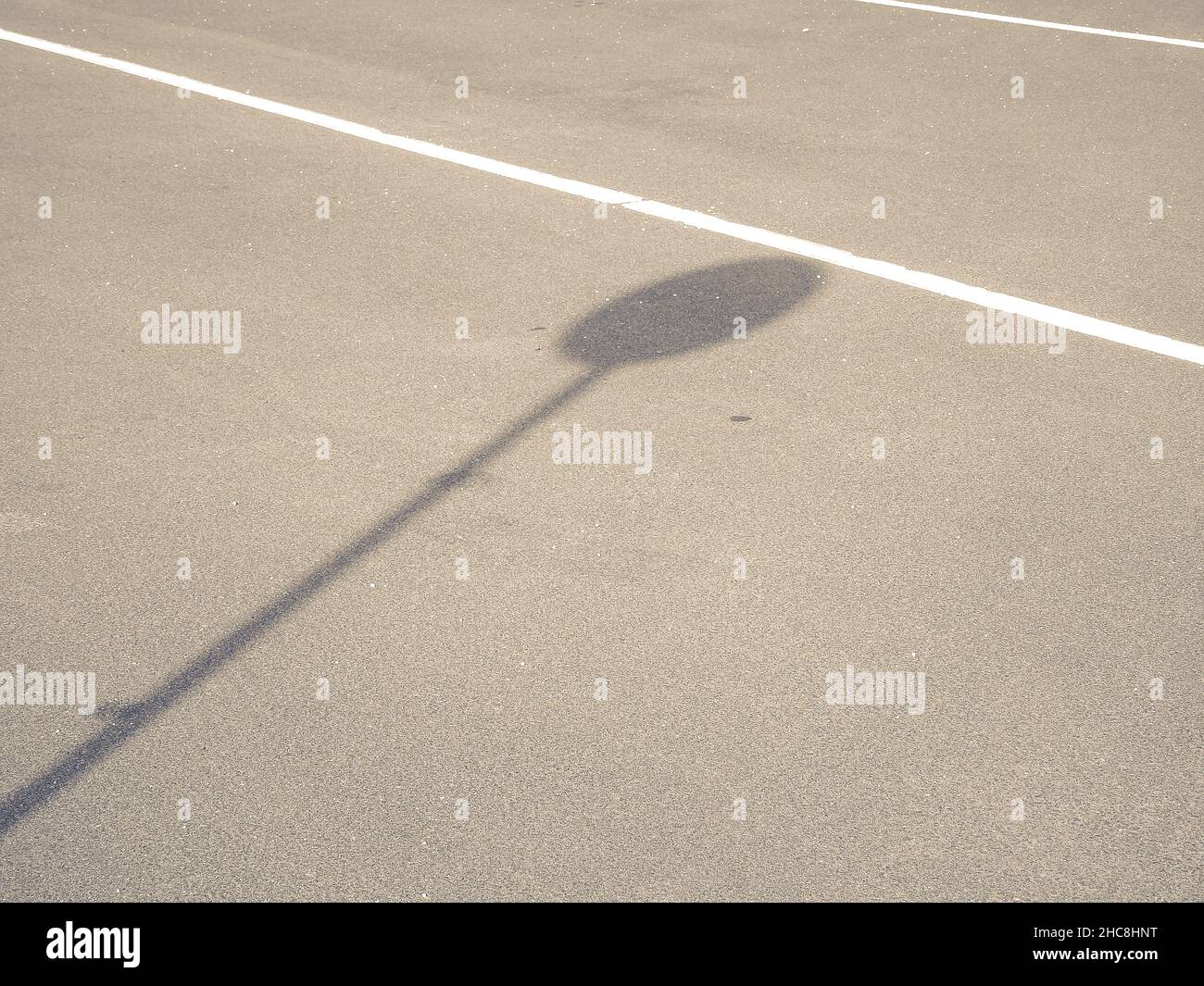 Road with white line-markings and a sign shadow Stock Photo - Alamy