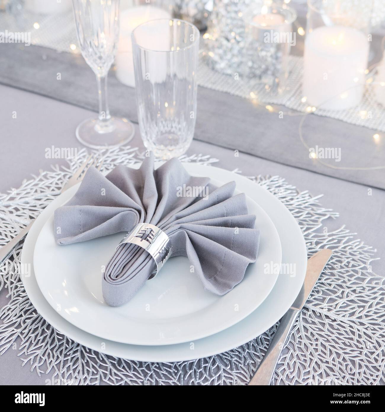 Beautiful table setting with Christmas decorations. Silver colors Stock ...