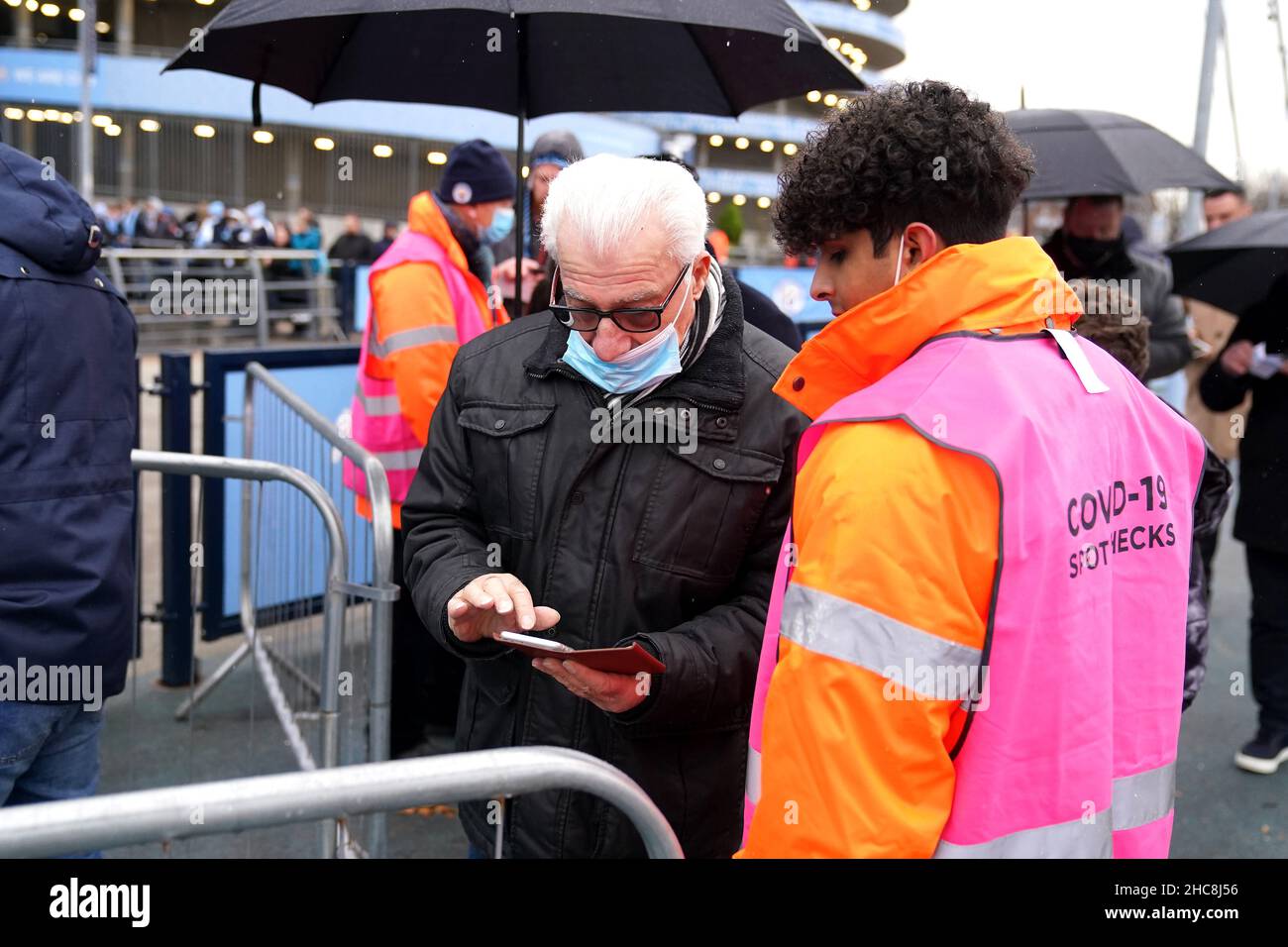 Covid-19 spot checkers check fans passes outside the ground before the ...