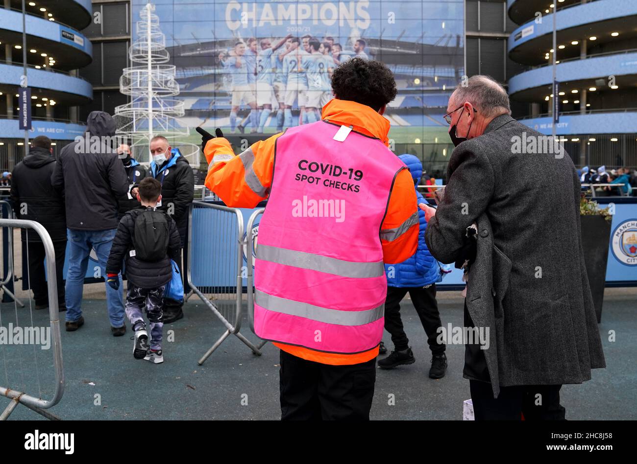 Covid-19 spot checkers check fans passes outside the ground before the ...