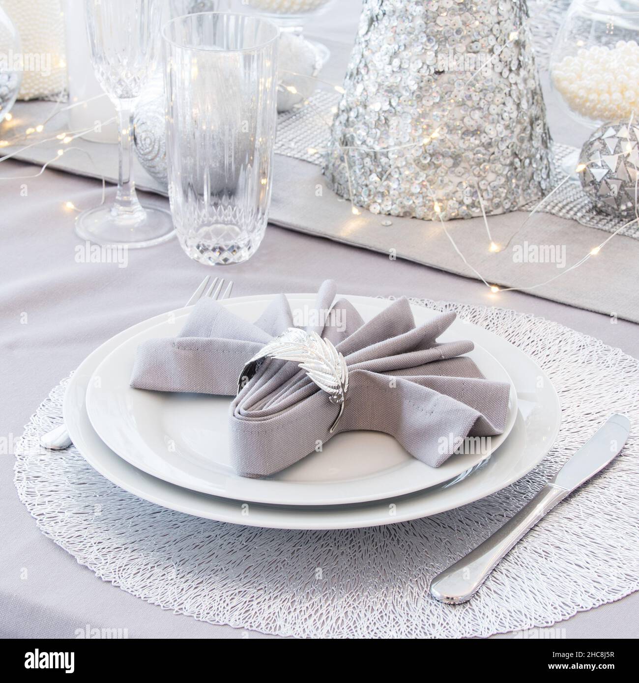 Beautiful table setting with Christmas decorations. Silver colors Stock ...