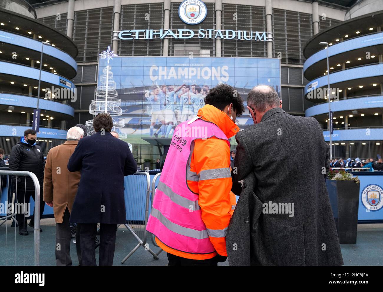 Covid-19 spot checkers check fans passes outside the ground before the ...