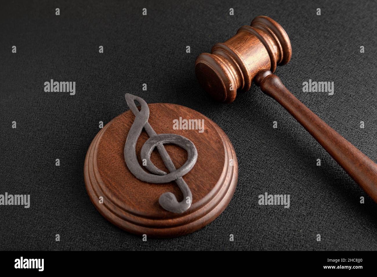 Music symbol treble clef and judge gavel on black background. Music ...