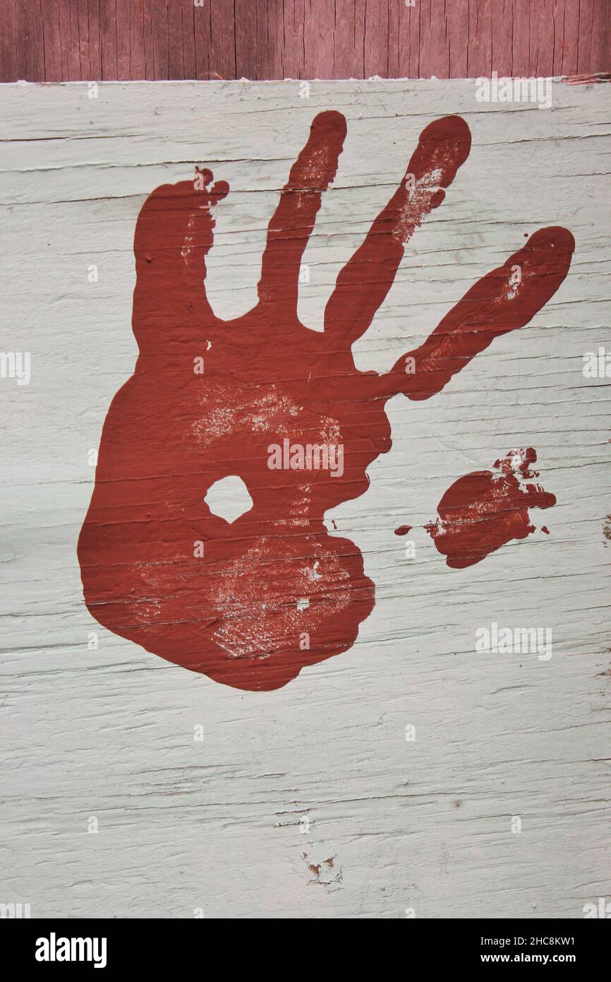 Old wooden plank painted with the hand print of a left hand Stock Photo ...
