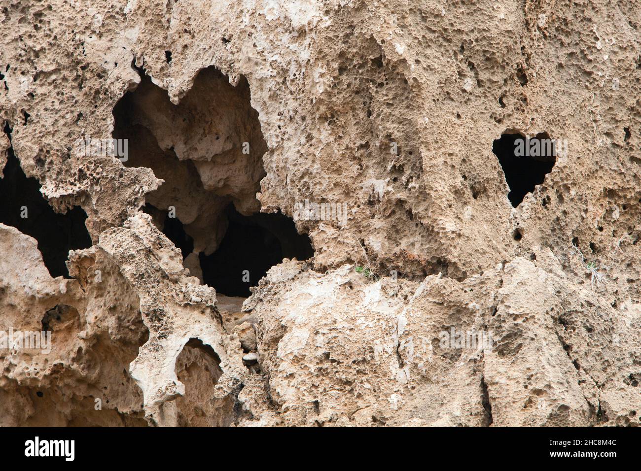 Volcanic lava, pumice rock formation, showing a heart shaped hole ...