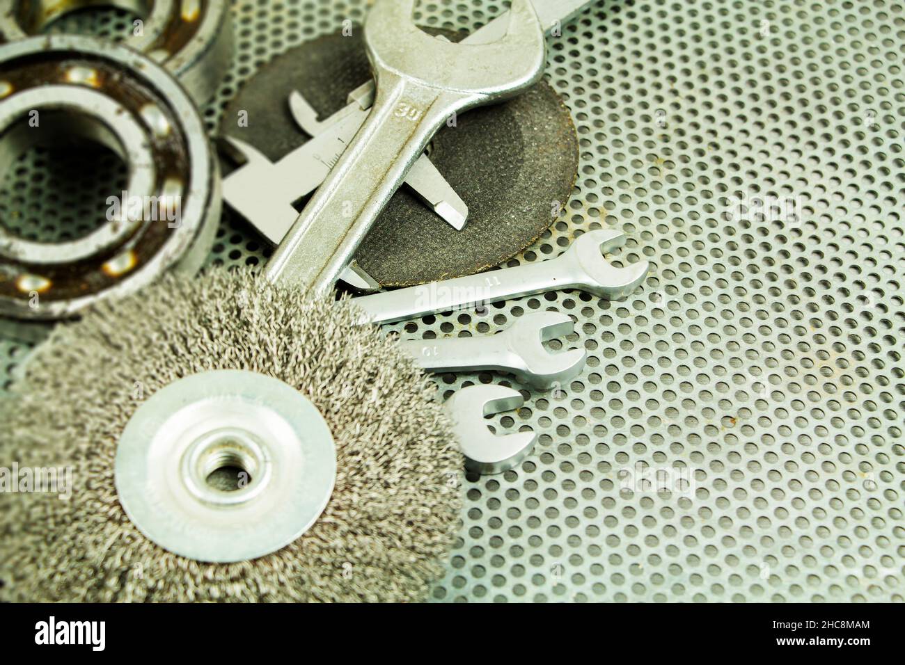 Metalworking tools, steel parts, a wrench, on the background of a metal ...