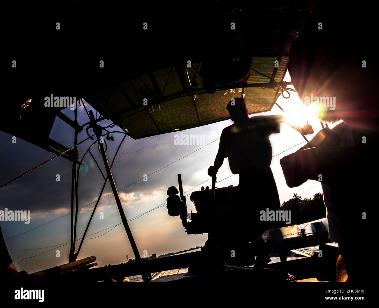 Silhouette of a passenger boat driver in the daytime backlit Stock ...